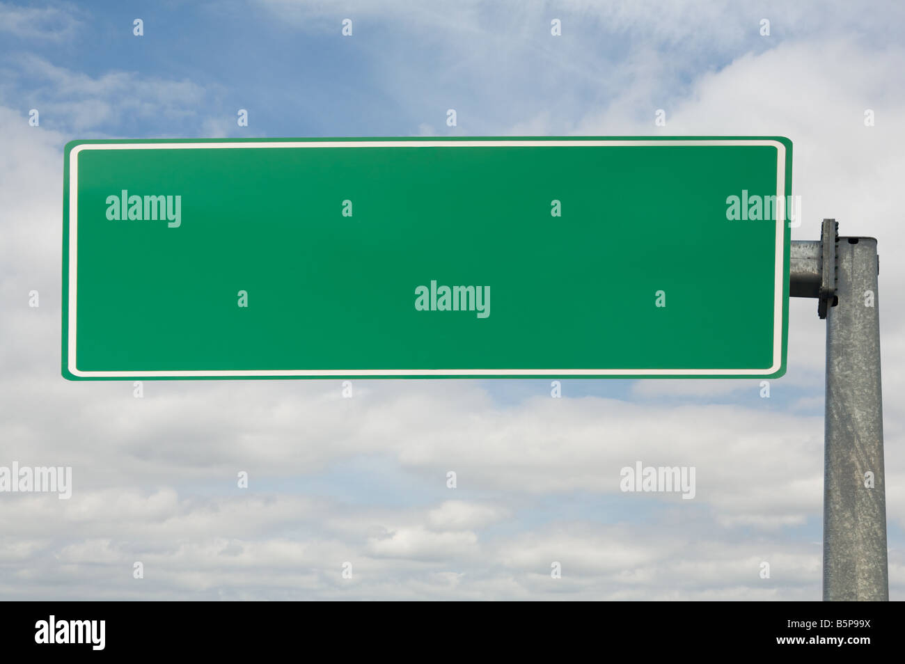 A large green traffic sign with wall street on it Stock Photo - Alamy
