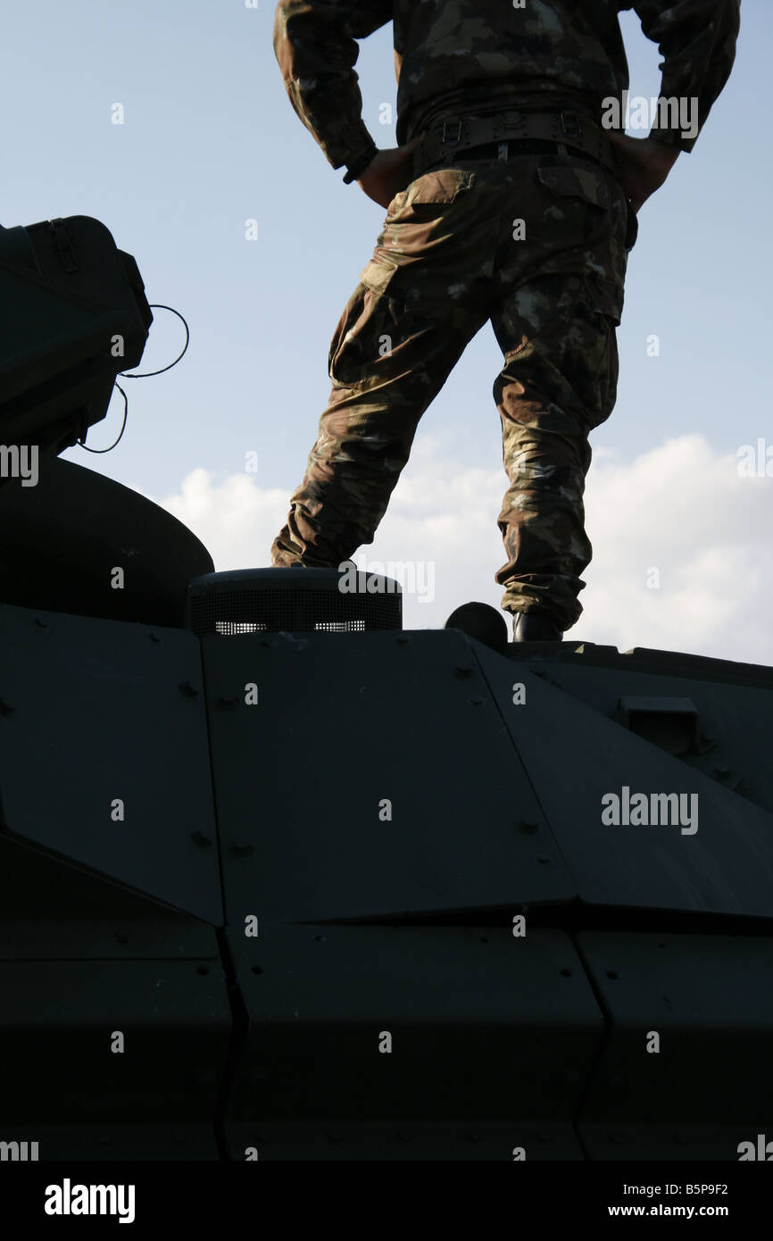 one soldier standing on armoured tank at open day Stock Photo - Alamy