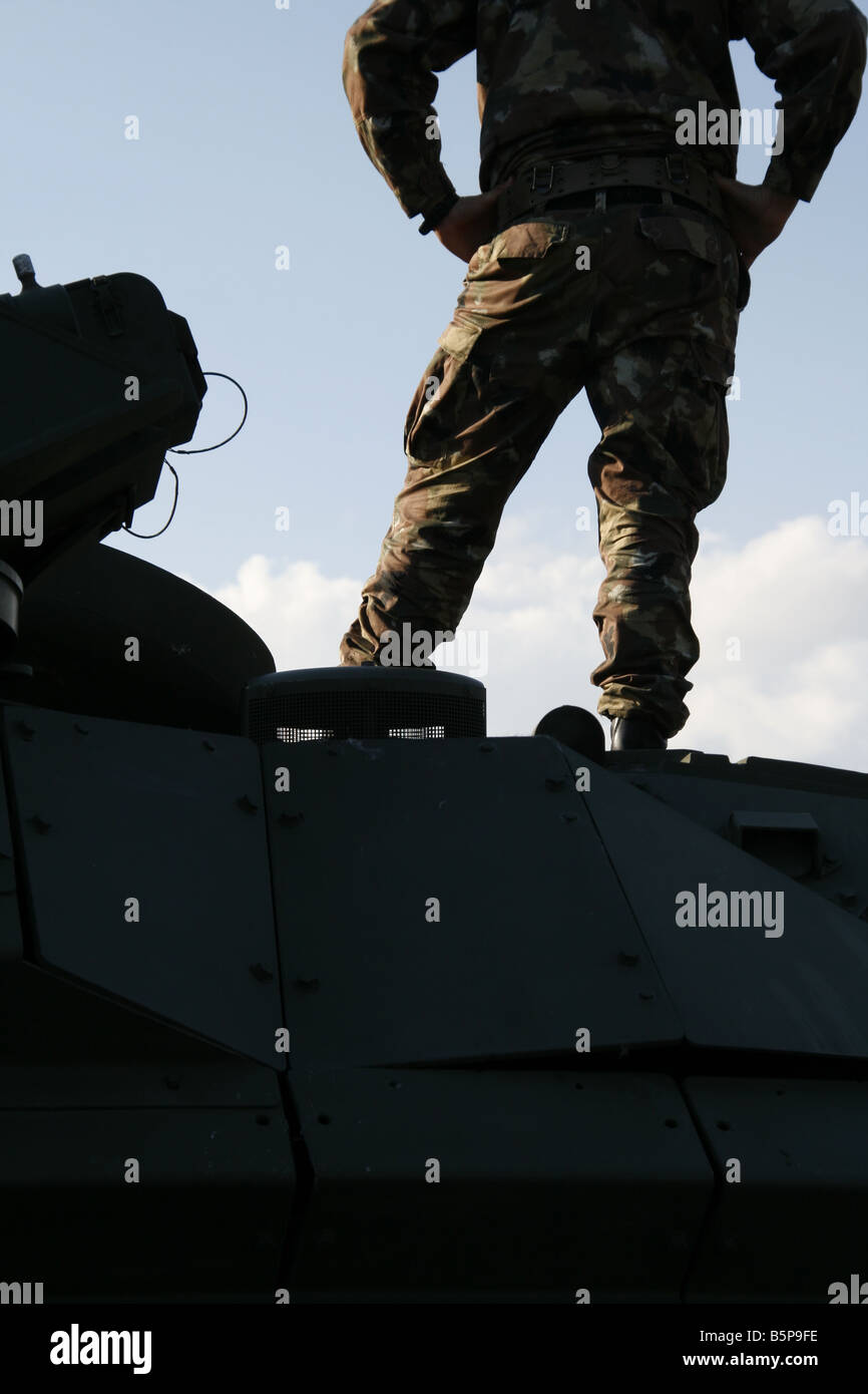 one soldier standing on armoured tank at open day Stock Photo - Alamy