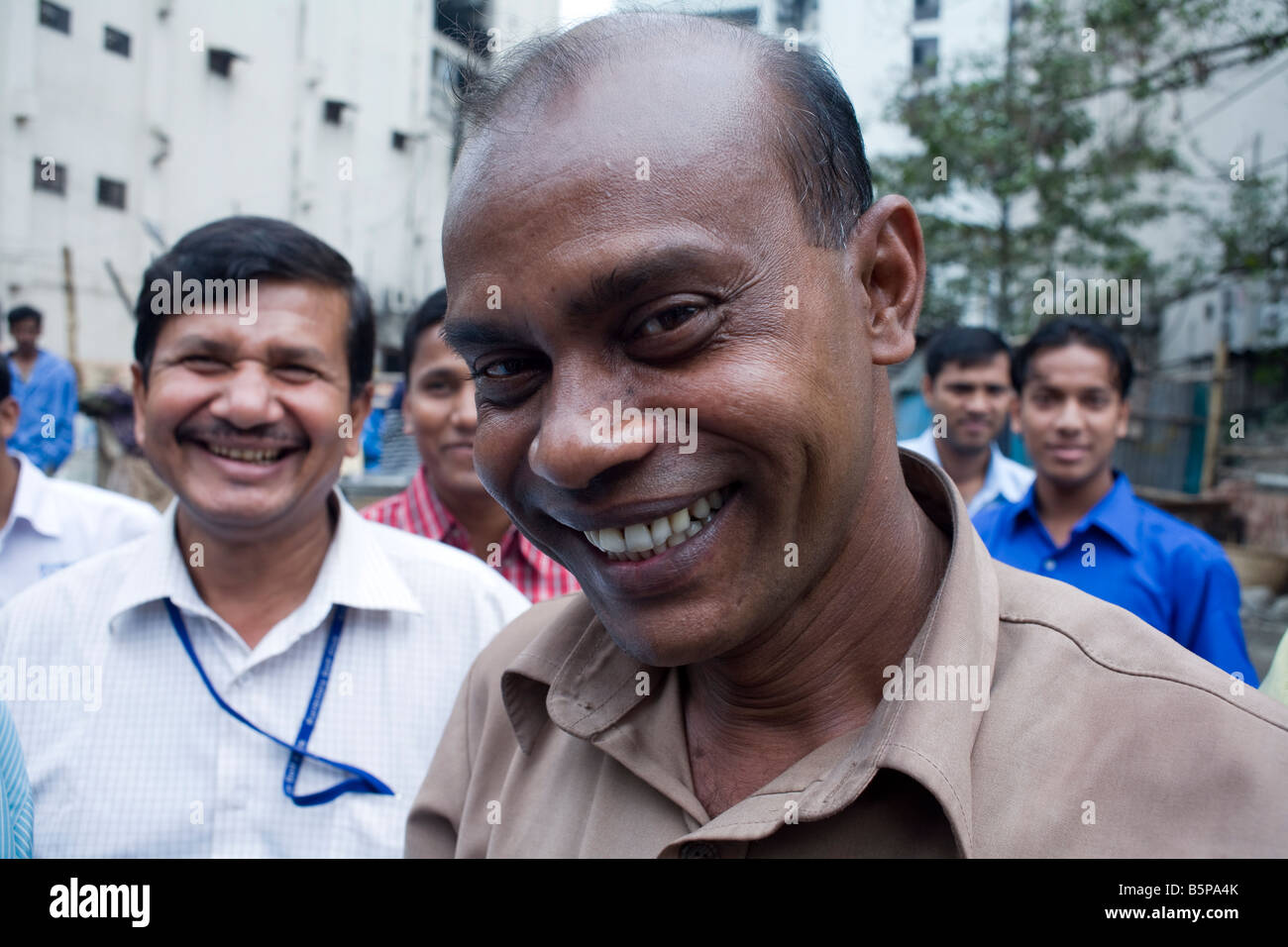 A man smiling into the camera in Dhaka Stock Photo - Alamy