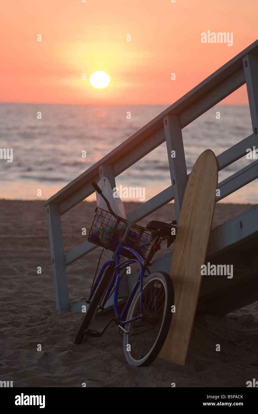Sunset at Venice Beach with beach cruiser and surfboard leaned against ...