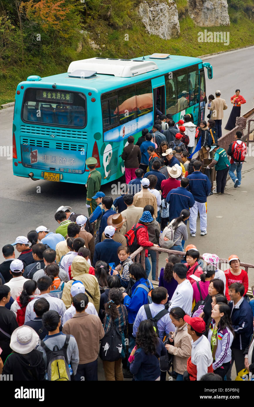 Crowd of Chinese tourists boarding shuttle bus in Jiuzhaigou nature ...
