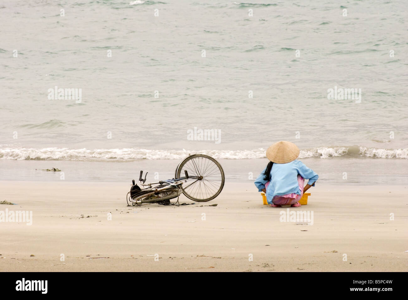 vietnamese woman seated on the beach, poulo condor island, vietnam ...