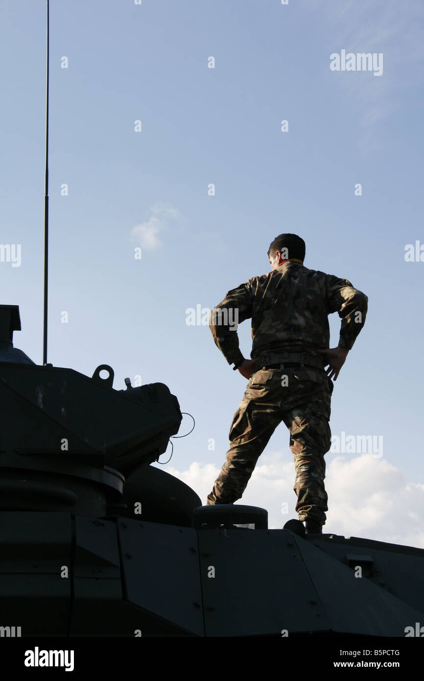 one soldier standing on armoured tank at open day Stock Photo - Alamy