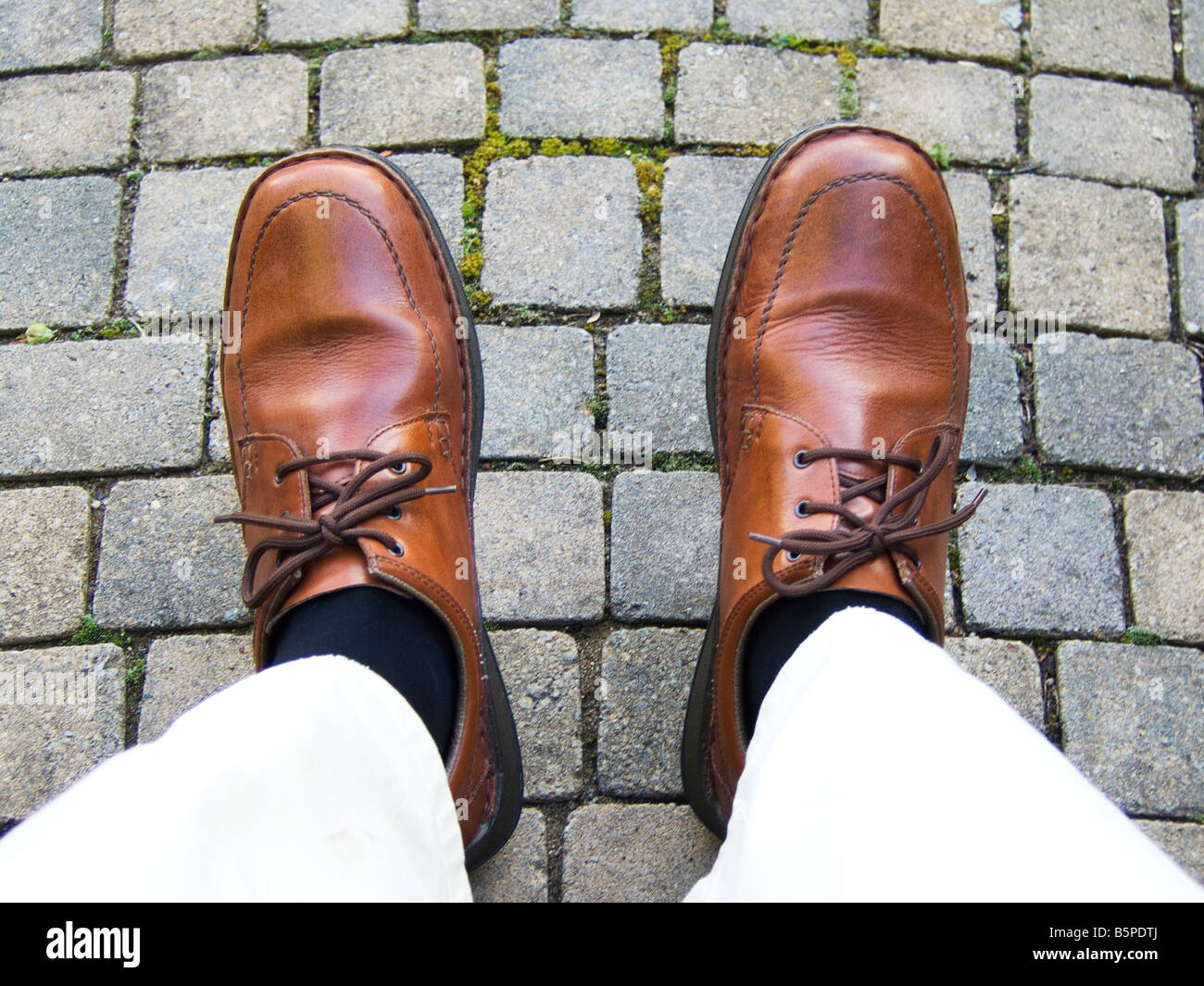 A man's feet in brown shoes Stock Photo - Alamy