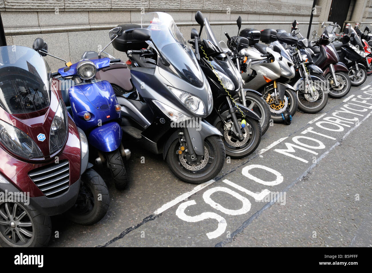 Row motorcycle motorbike parking hi-res stock photography and images ...