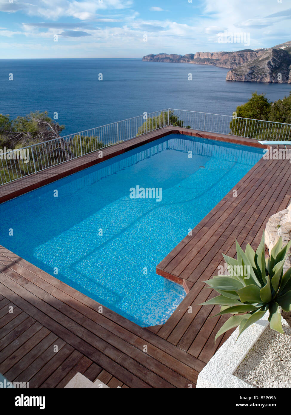 Swimming pool overlooking sea on sunny day Stock Photo - Alamy