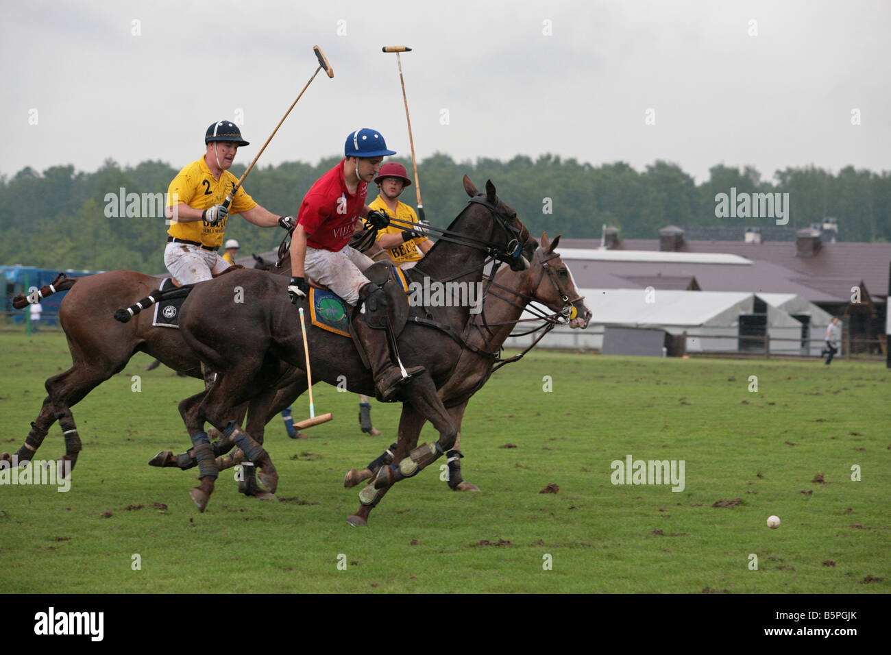 Polo players battle for position as they race down field Stock Photo ...