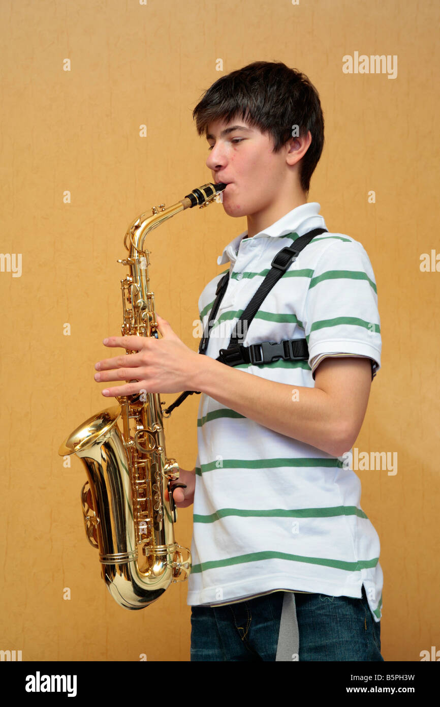 teenage boy playing the saxophone Stock Photo - Alamy