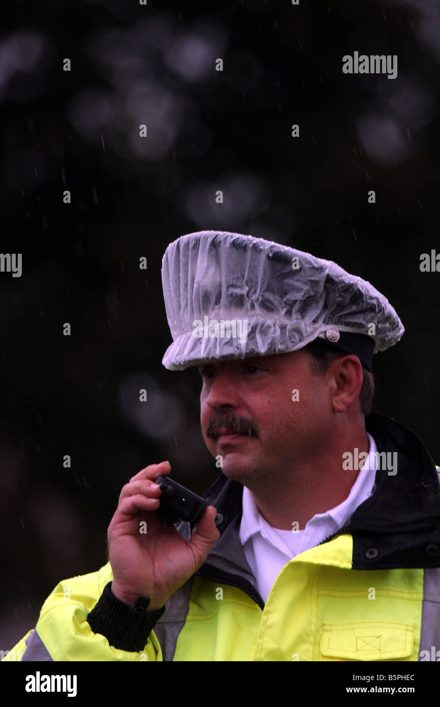 A fire Captain in his rain gear listening to his communication radio ...