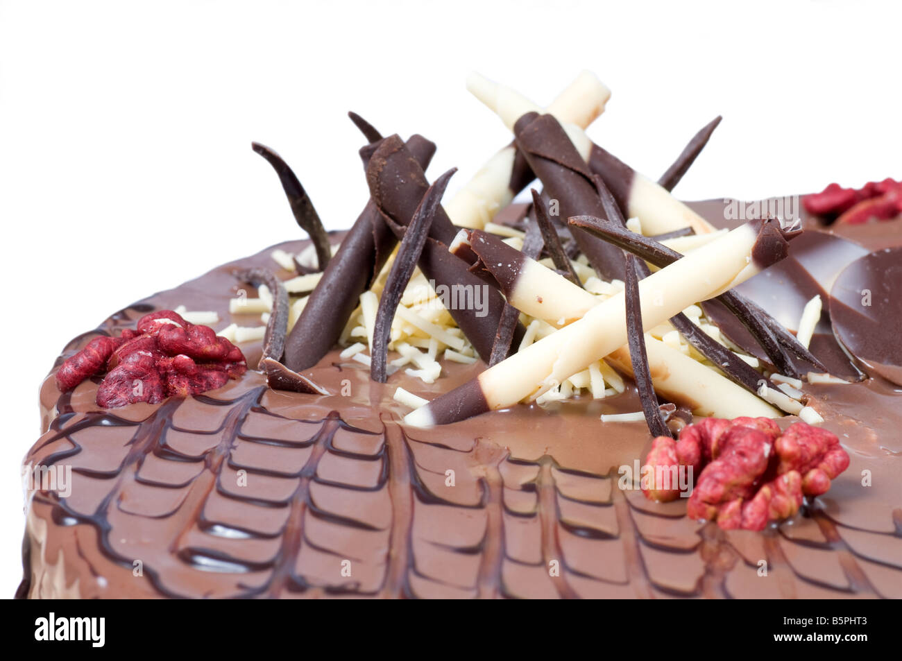 Detail of birthday cake with walnuts and decoration on white background ...