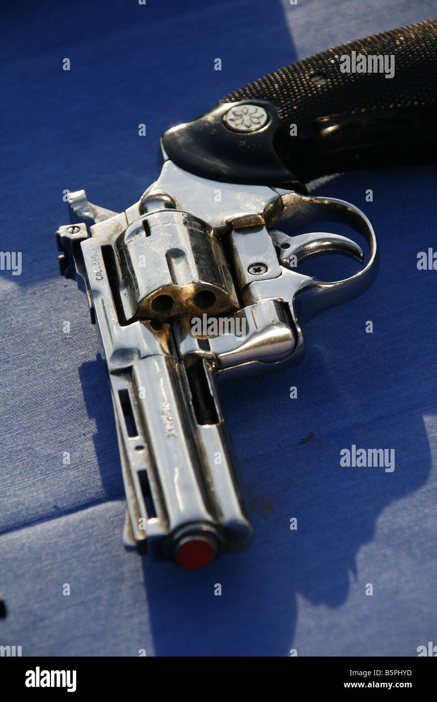 one pistol revolver gun on blue table Stock Photo - Alamy
