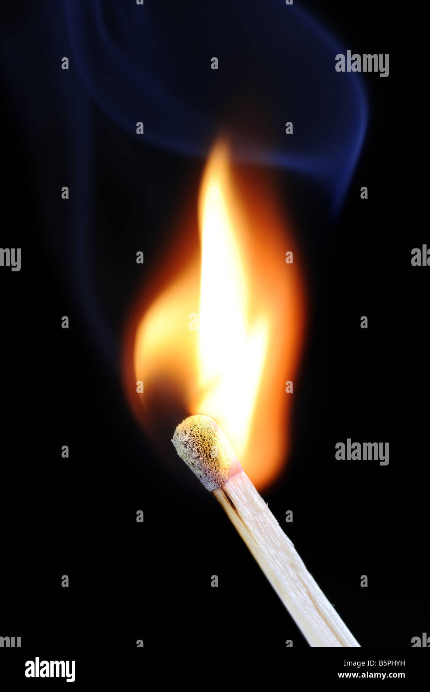 Burning fire of a match on black background with blue smoke above Stock ...