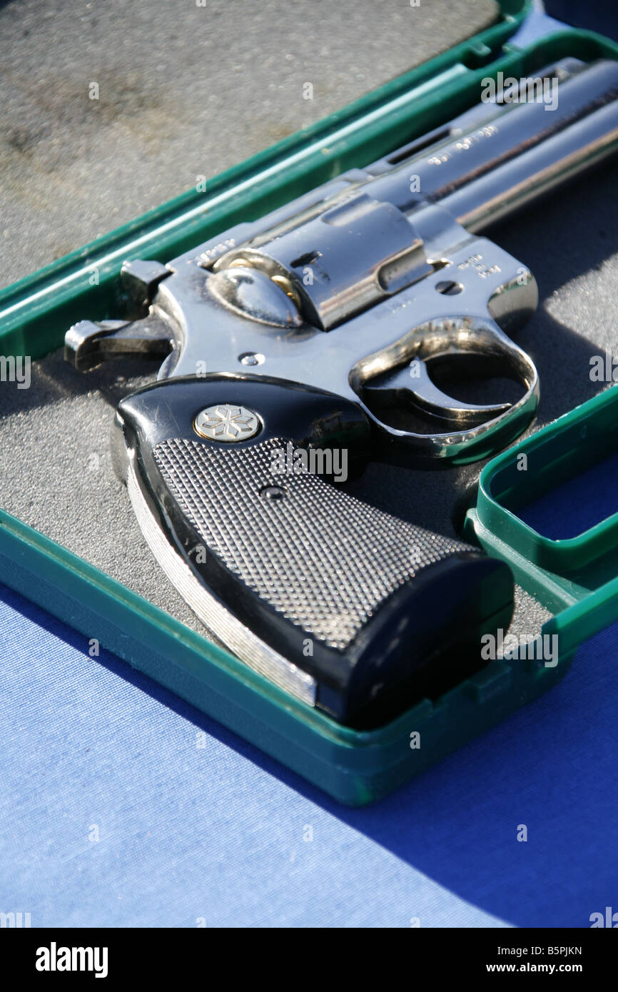 pistols revolvers guns on blue table Stock Photo - Alamy