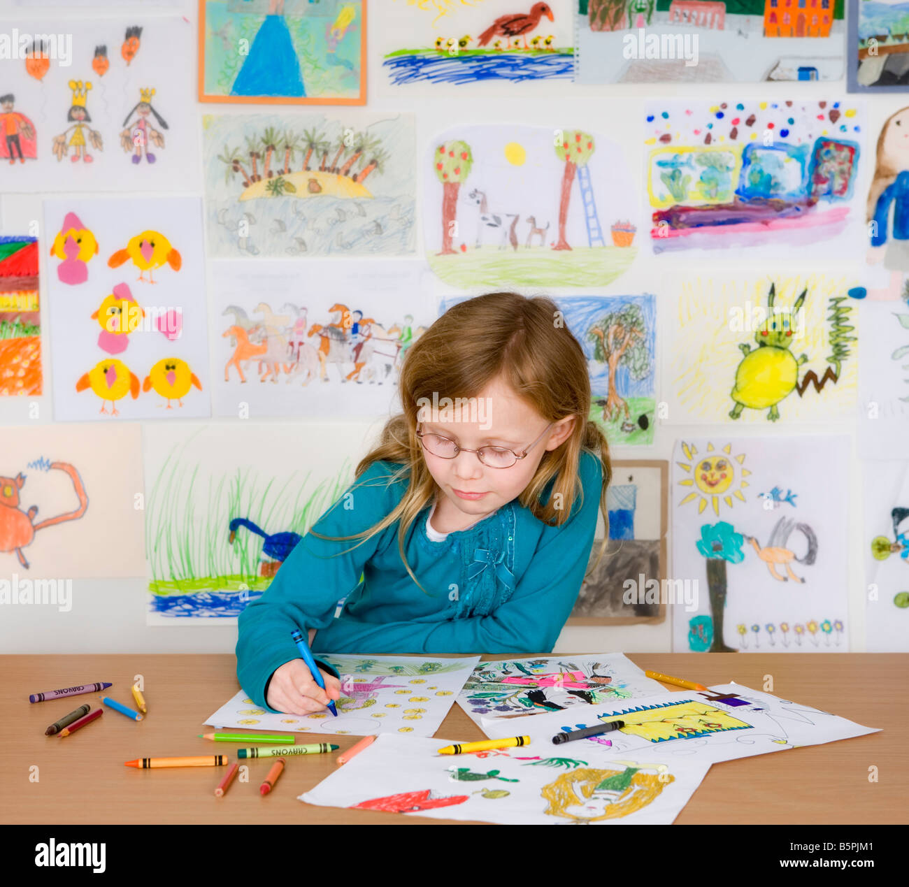 Girl drawing with crayons on paper Stock Photo - Alamy