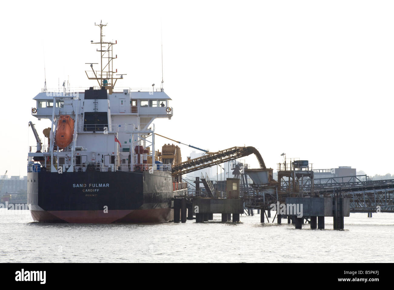 A ship called the Sand Fulmar of Cardiff unloads it's cargo of sand via ...