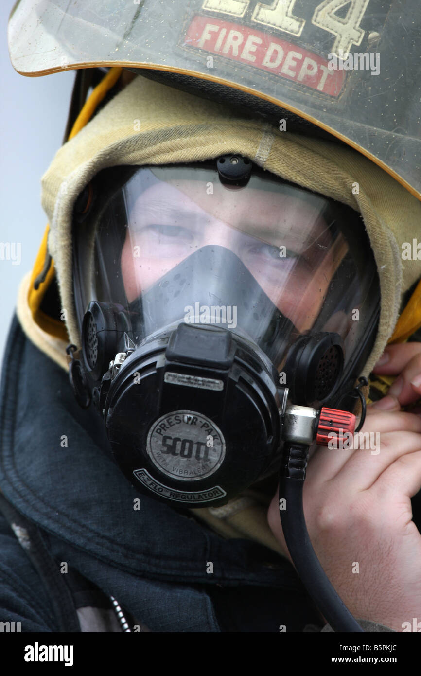 A fire fighter adjusting his breathing scba unit Stock Photo - Alamy