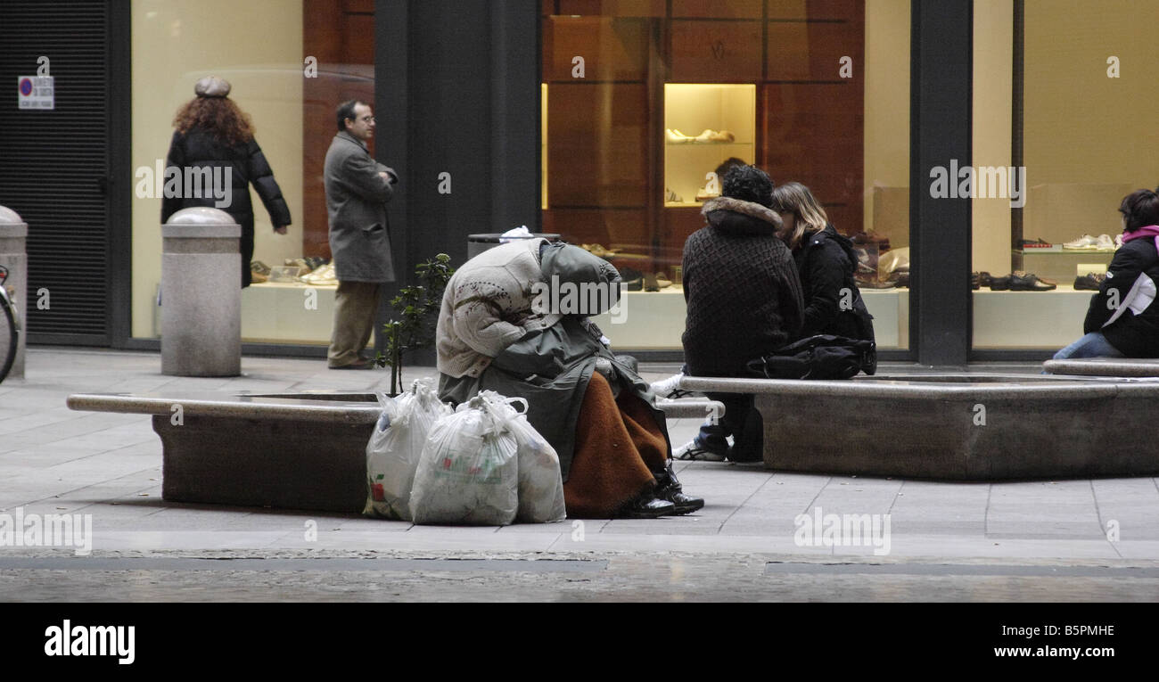 An homeless sitting on a bench with his bags. Shopping place, Luxury ...