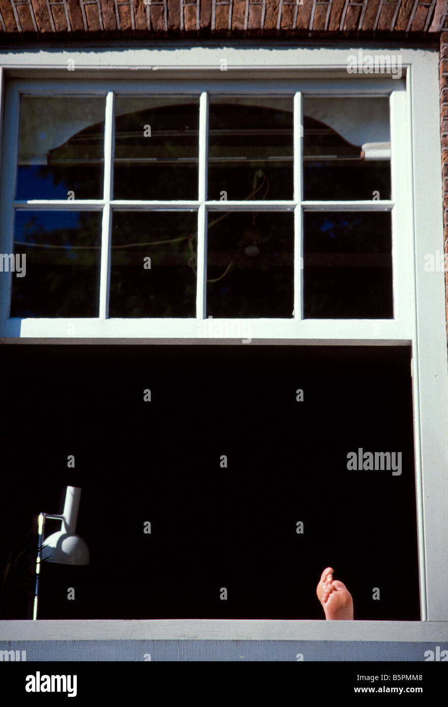 Foot at the window Stock Photo - Alamy