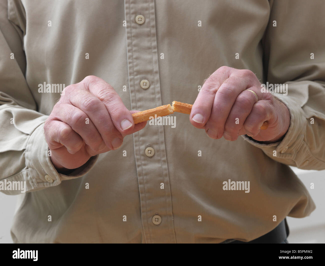 Person Breaking a Breadstick Stock Photo - Alamy