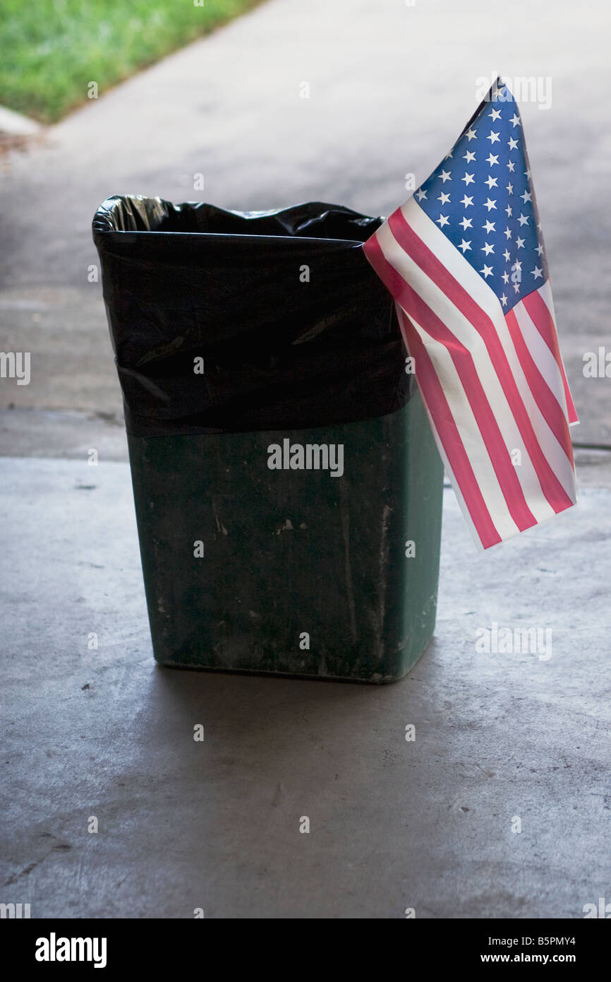 American flag resting in trash can Stock Photo - Alamy