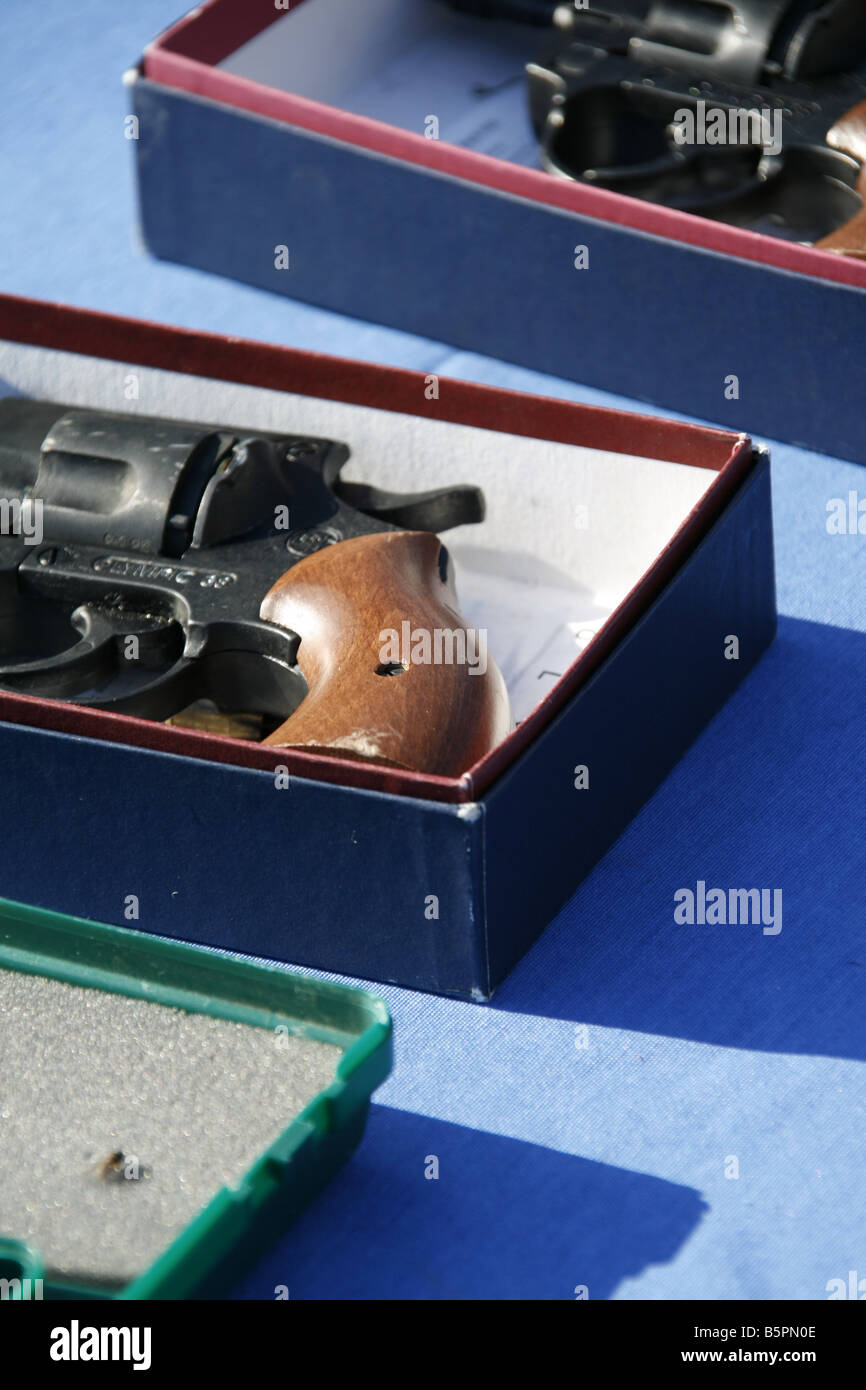 pistols revolvers guns on blue table Stock Photo - Alamy