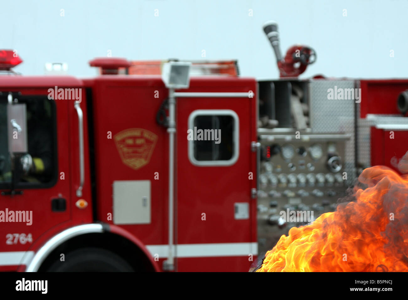 A rolling flaming car fire in front of a fire truck Stock Photo - Alamy