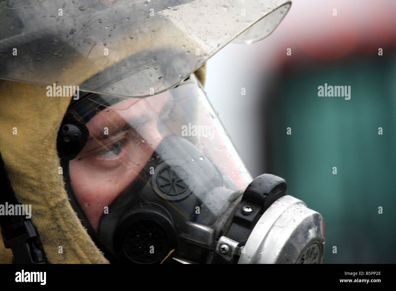 A closeup of a firefighter at a fire scene fighting a fire Stock Photo ...