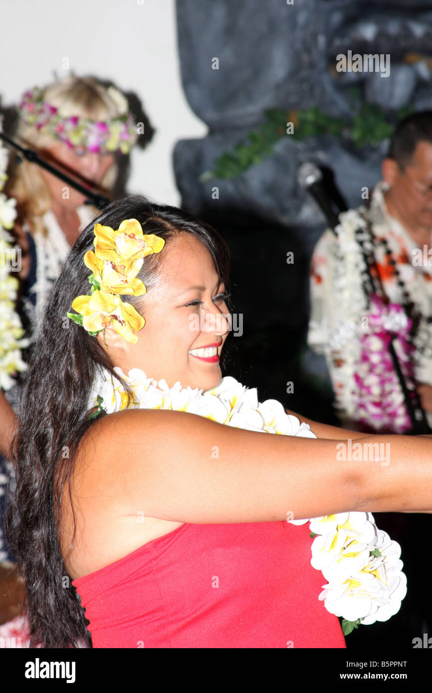 A female Hawaiian Dancer performing with the musical instruments played ...