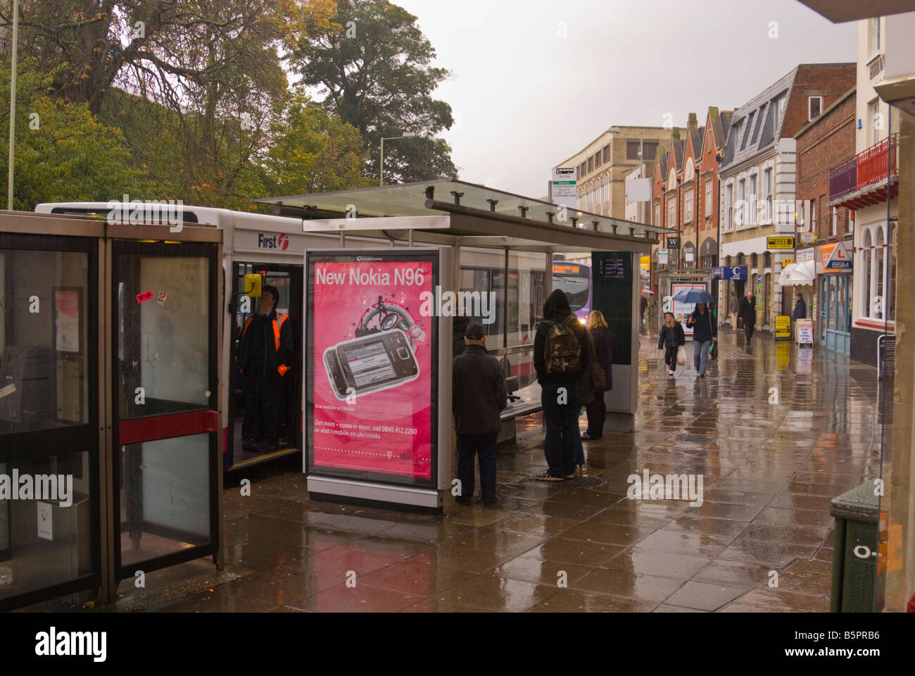 Waiting for bus in the rain hi-res stock photography and images - Alamy