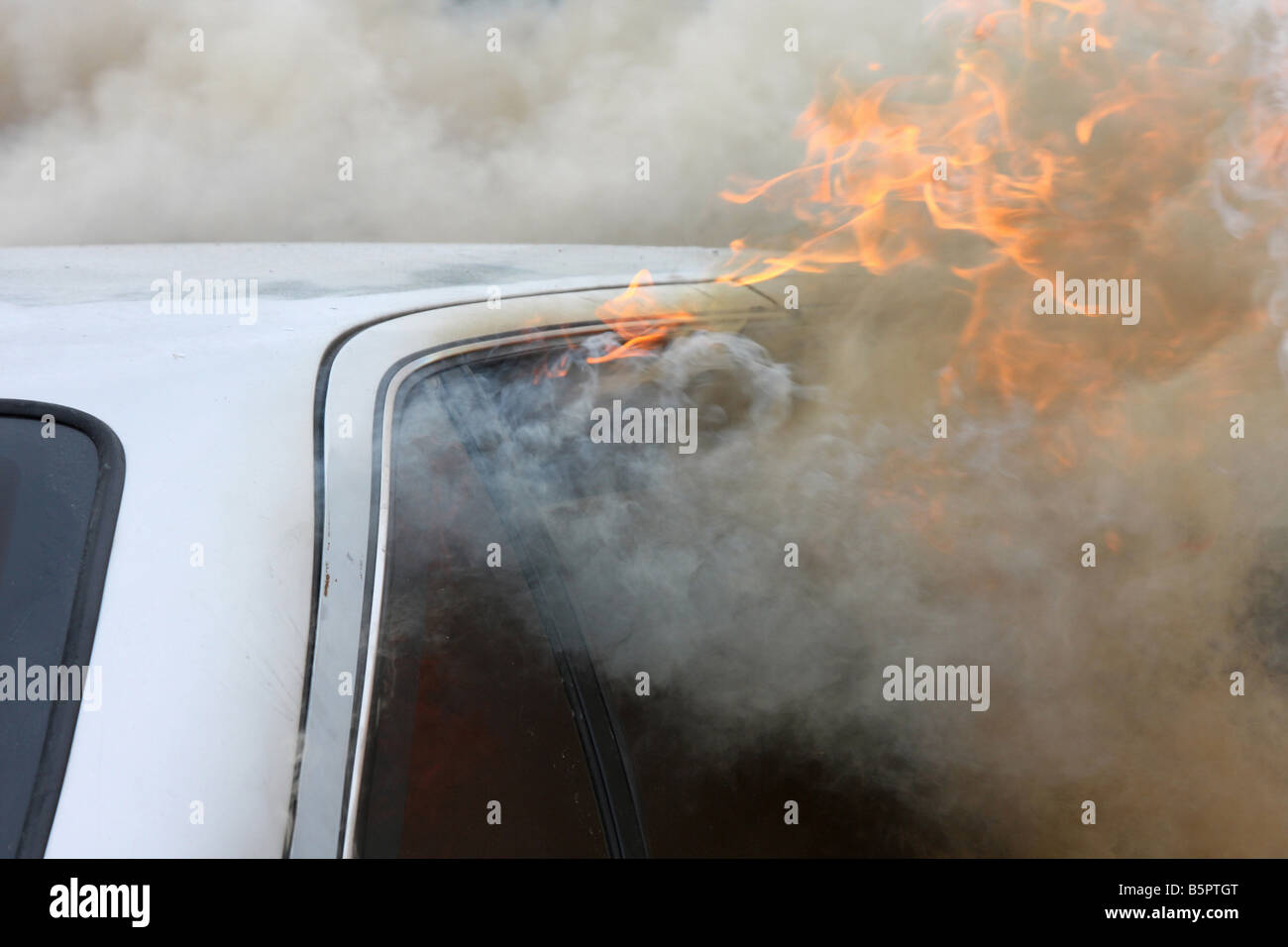 Smoke and flames coming out of a car during a car fire Stock Photo - Alamy