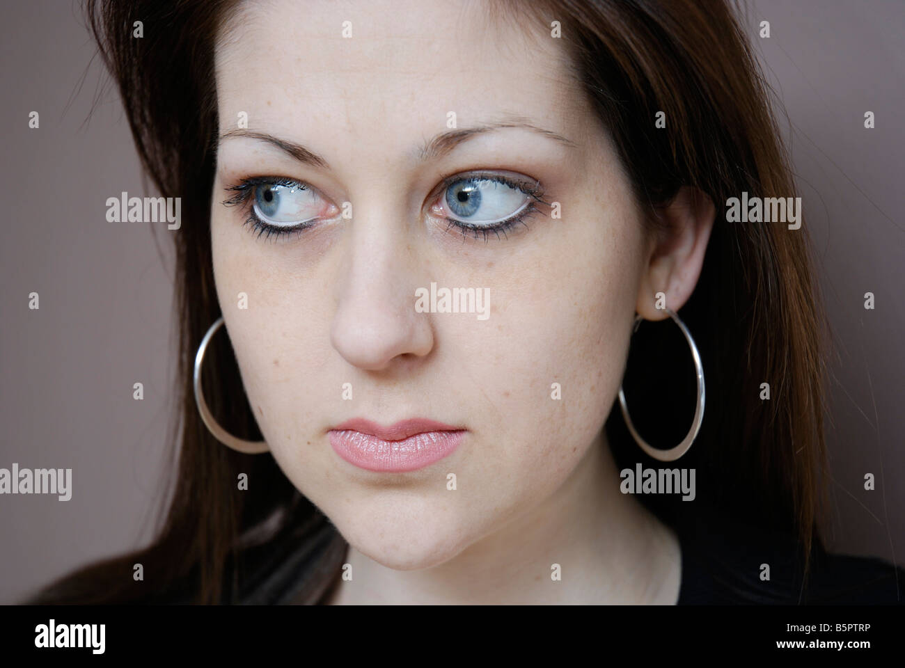 A young woman with an anxious expression Stock Photo - Alamy