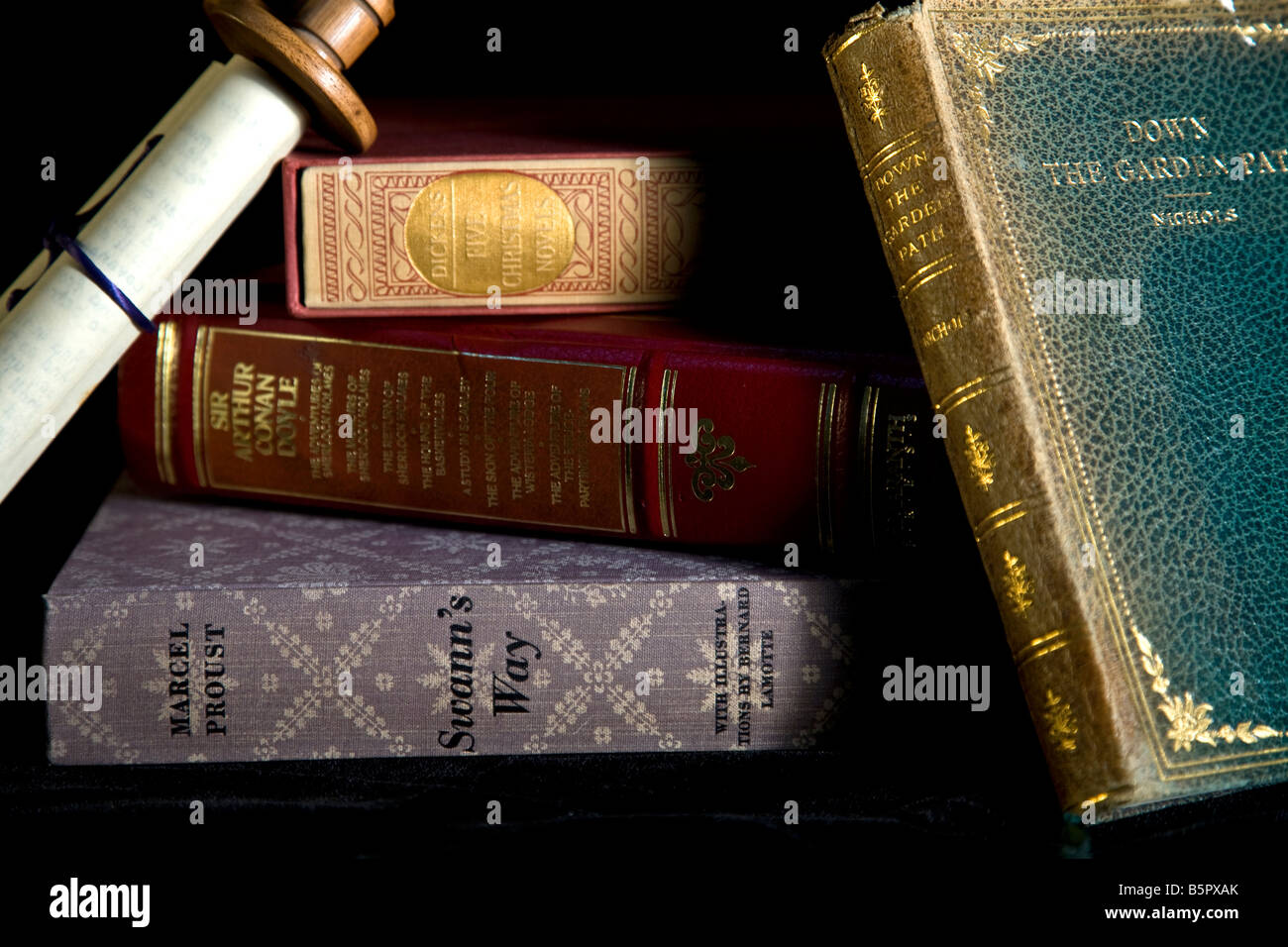 A still life of a stack of books with a scroll Stock Photo - Alamy