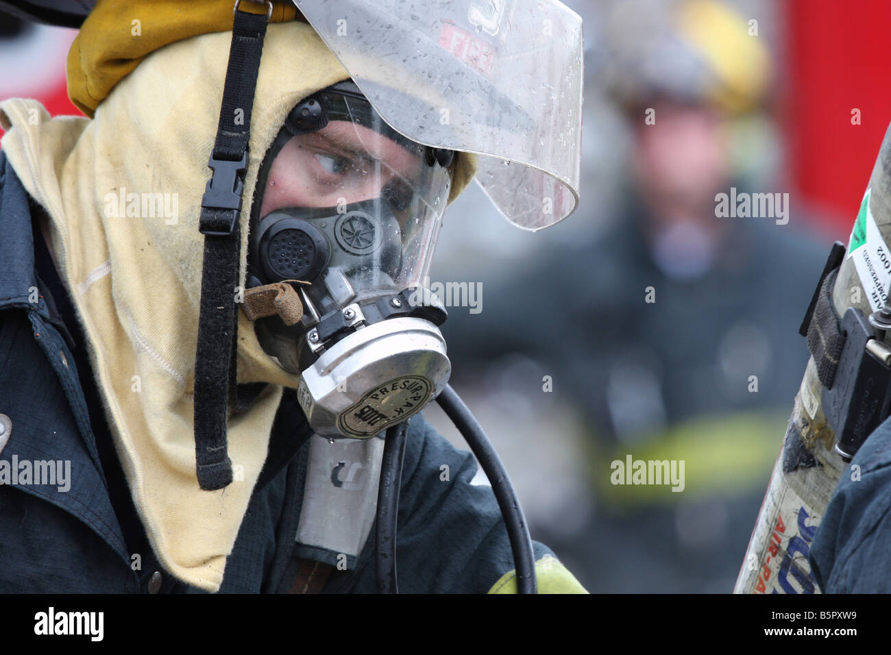 A closeup of a firefighter at a fire scene fighting a fire Stock Photo ...