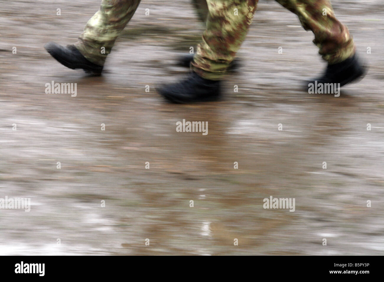 two soldiers feet marching on battlefield Stock Photo - Alamy