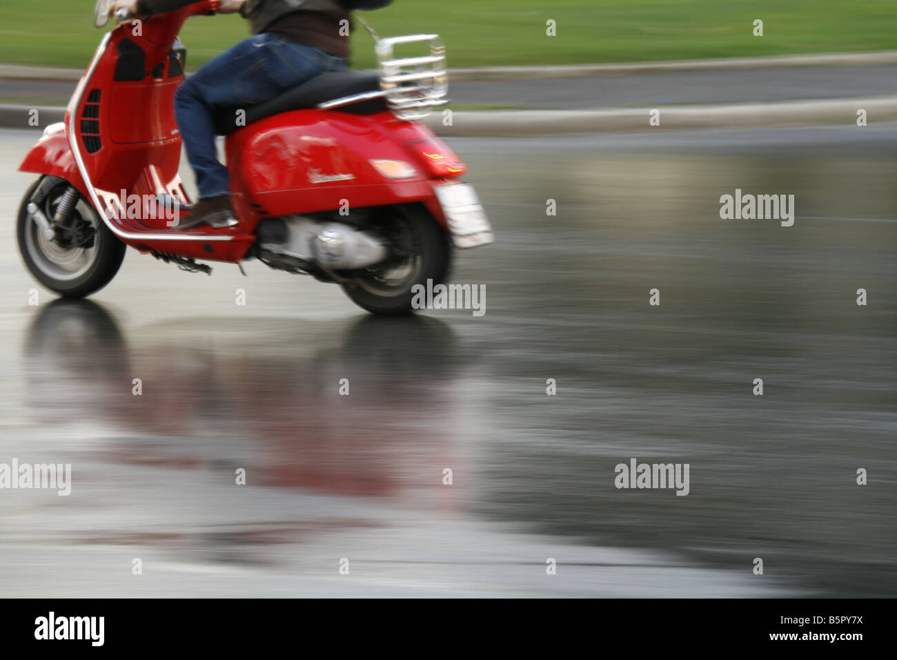 person riding red vespa scooter moped in rain in rome italy Stock Photo ...