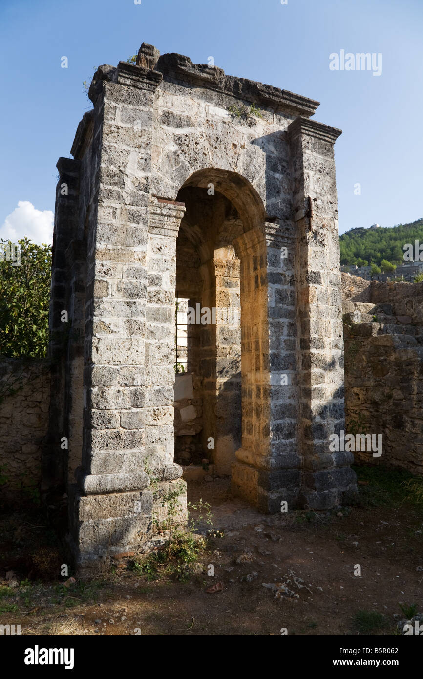 A derelict stone archway in the ghost town of Kayakoy in Turkey Stock ...
