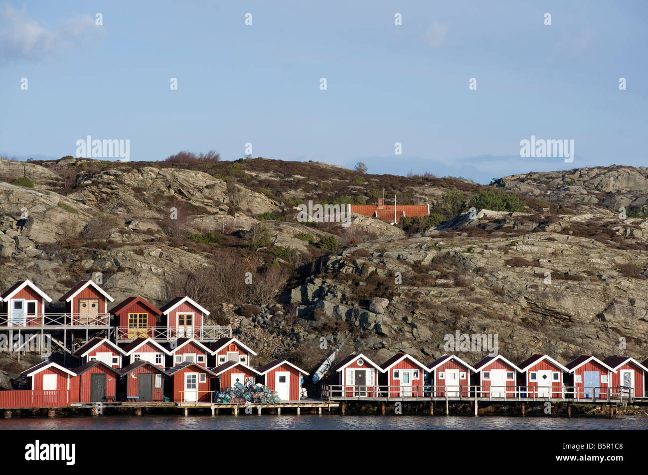 Brightly painted wooden summer bathing huts in Skarhamn Sweden's ...