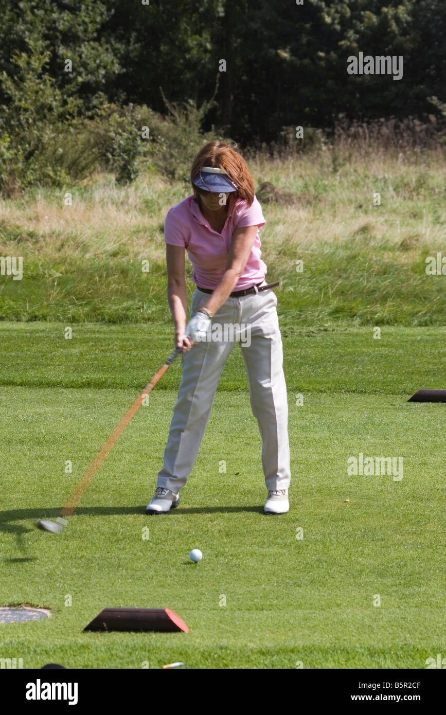Female golfer driving golf ball hi-res stock photography and images - Alamy