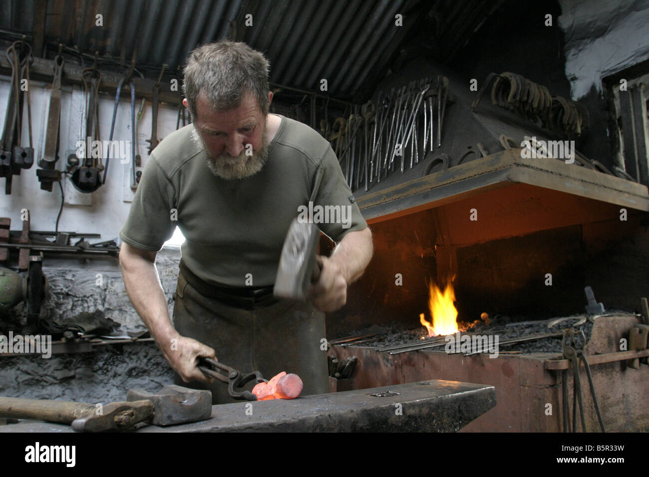 Blacksmith Bruce Wilcock at work in his Forge making a hammer Stock ...