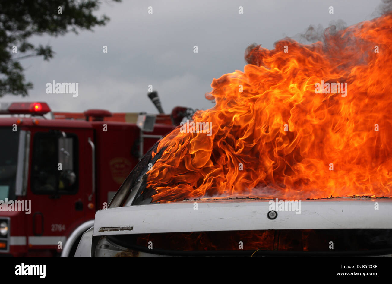 A firetruck at the scene of a car fire Stock Photo - Alamy