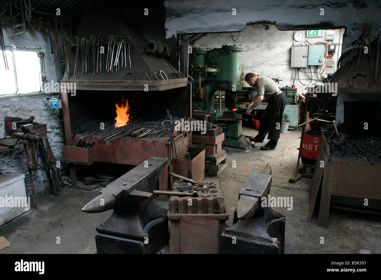 Blacksmith Bruce Wilcock at work in his Forge making a hammer Stock ...
