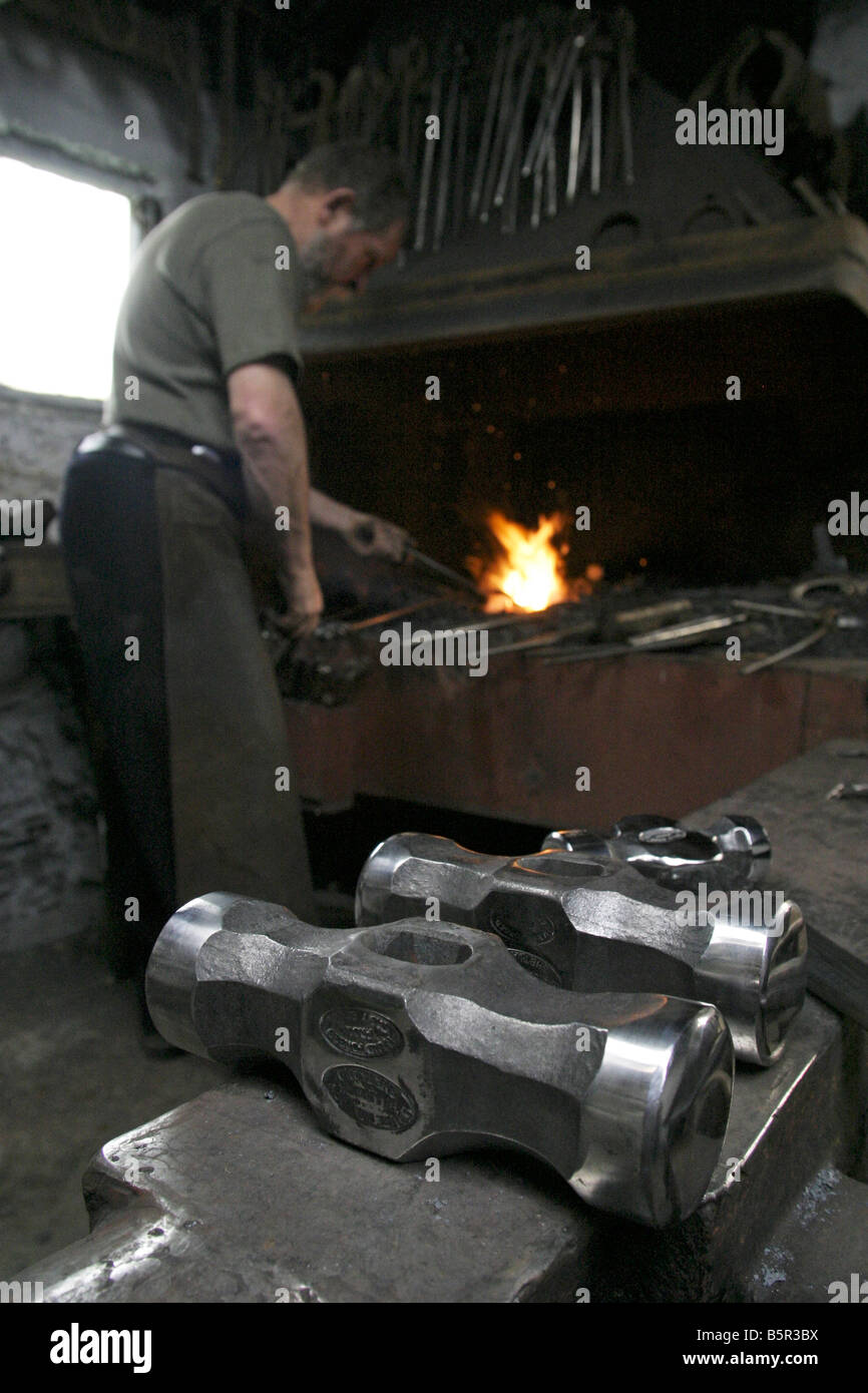 Blacksmith Bruce Wilcock at work in his Forge making a hammer Stock ...