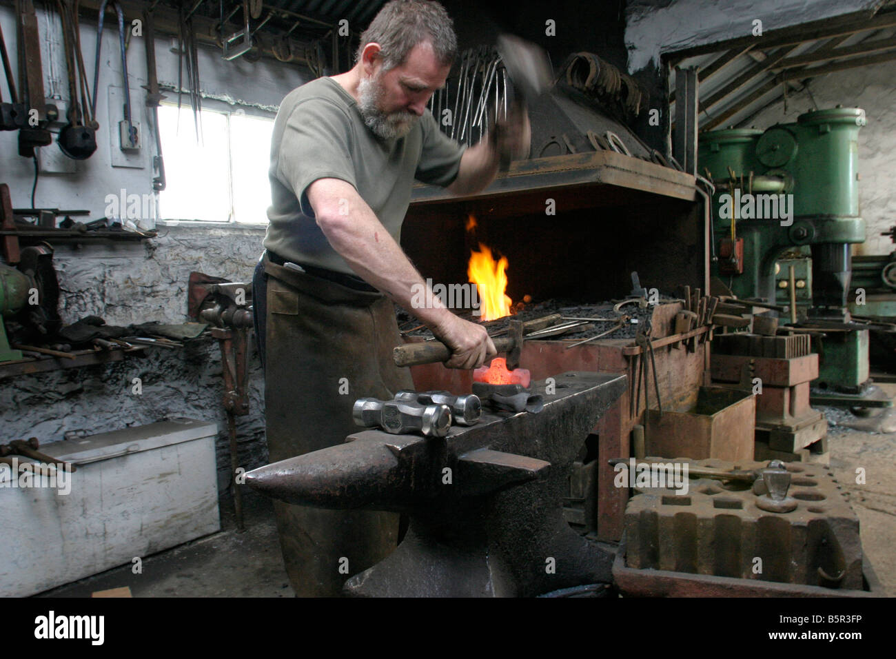 Blacksmith Bruce Wilcock at work in his Forge making a hammer Stock ...
