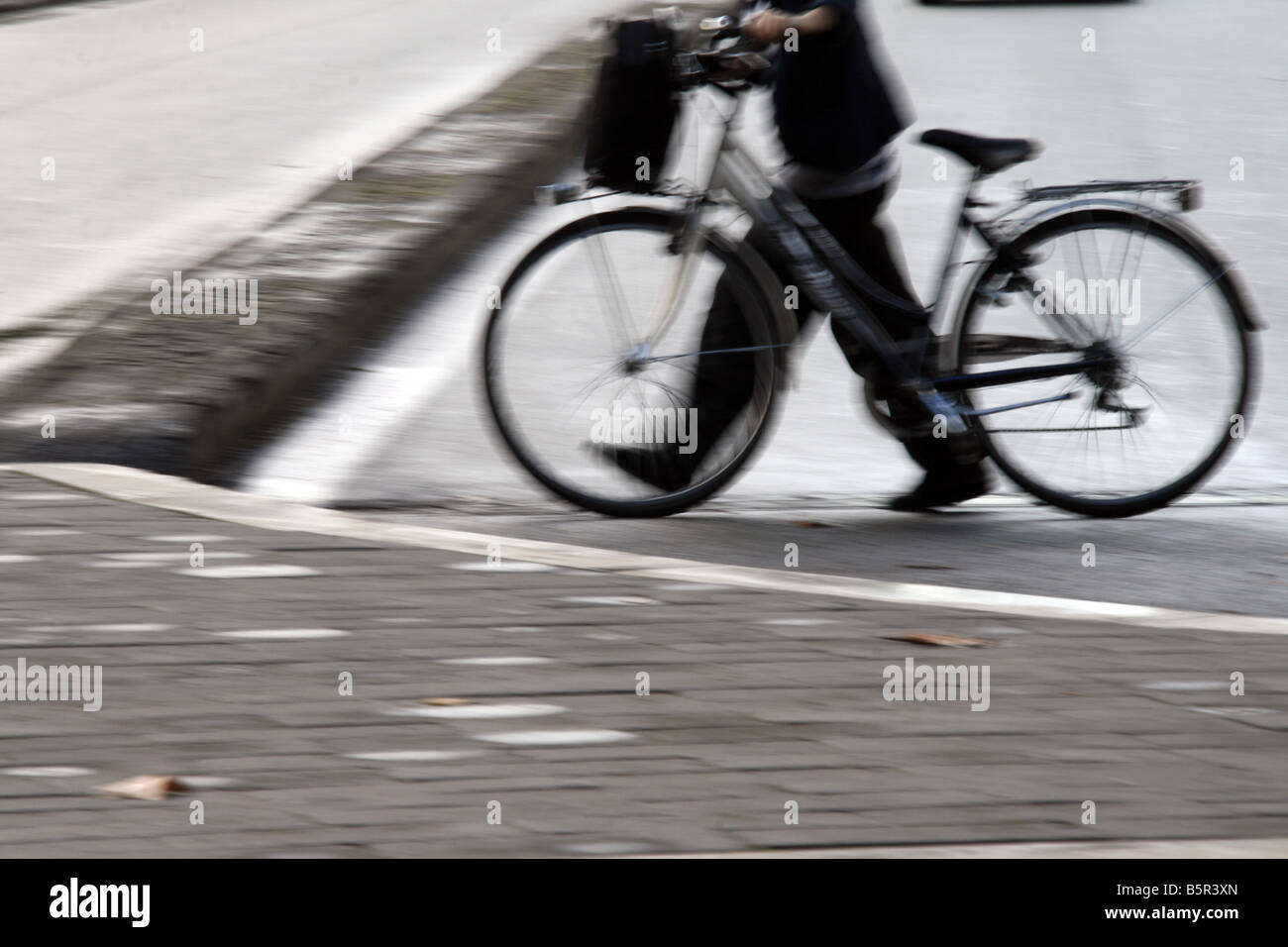 young woman pushing bike on street in town Stock Photo - Alamy
