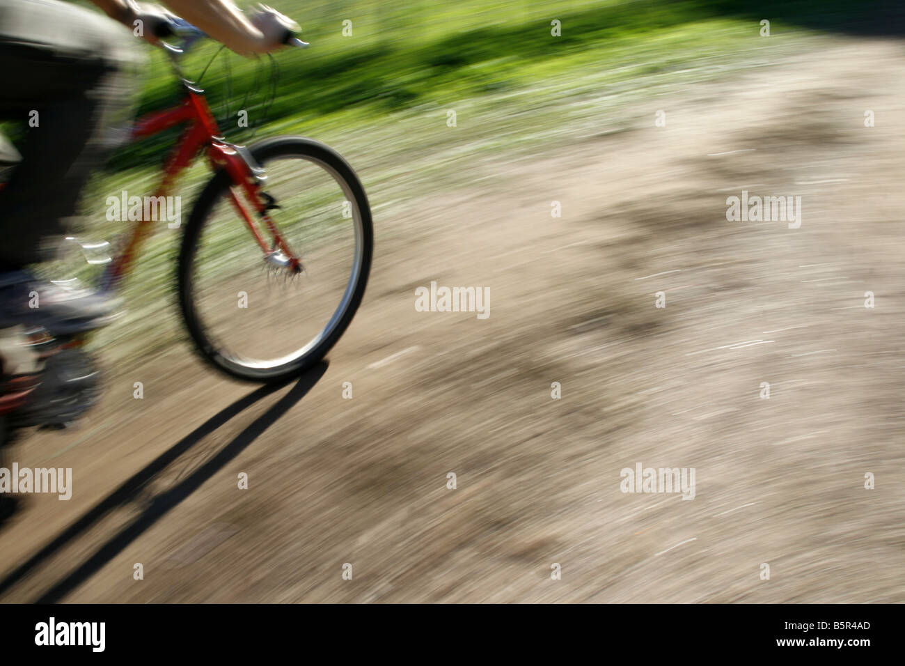 one person riding fast bike on off road path in countryside Stock Photo ...