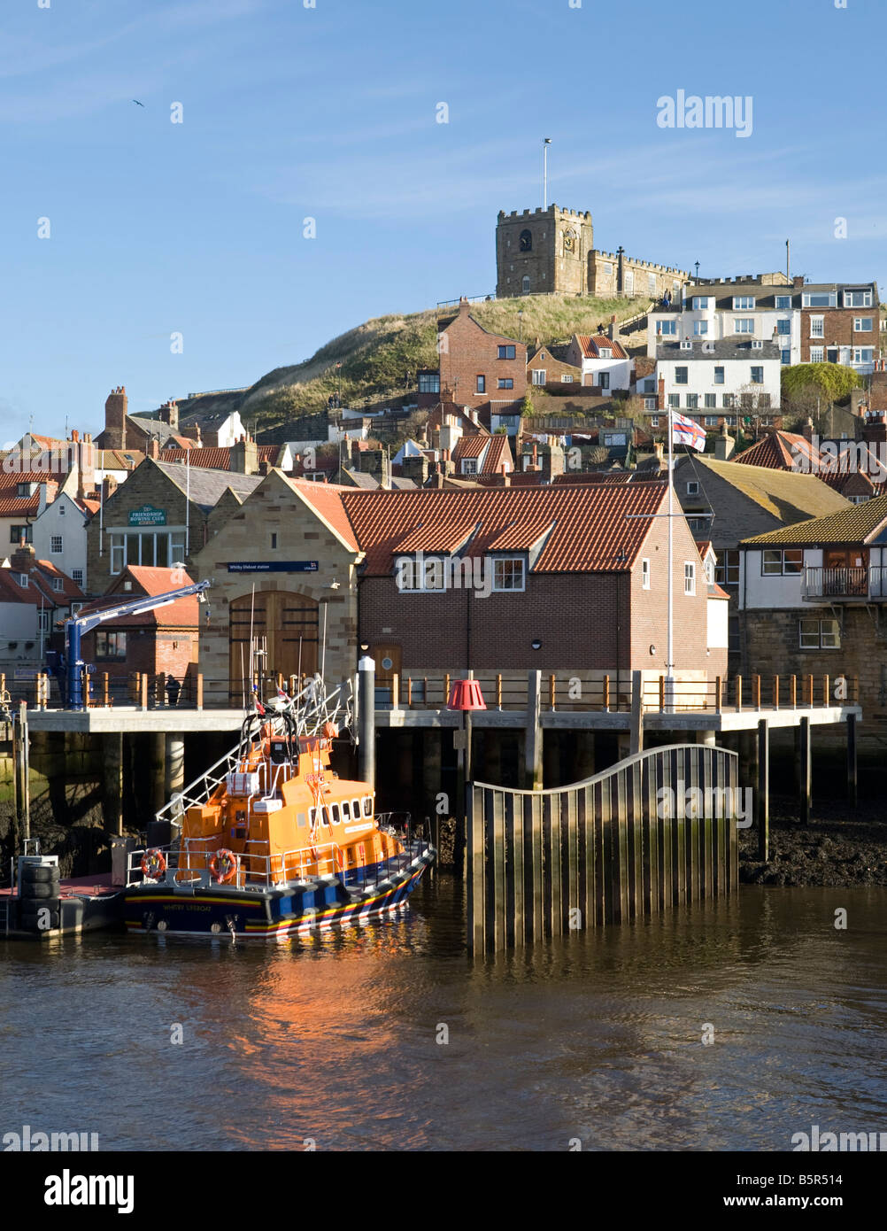 The RNLI lifeboat "Whitby Lifeboat" moored in Whitby harbour with St ...