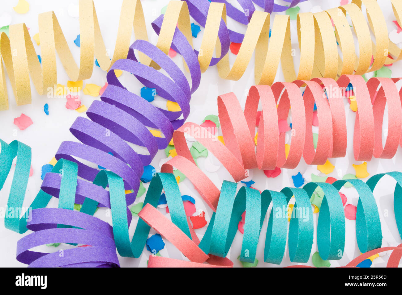 Several colourful party paper ribbons and confetti Stock Photo - Alamy