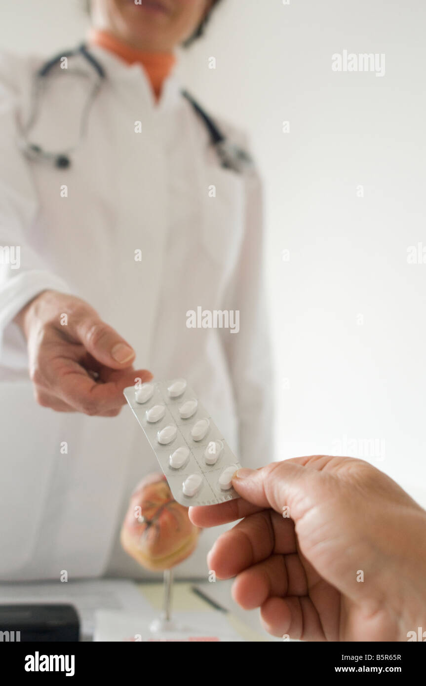 Doctor handing prescription drug to patient Stock Photo - Alamy