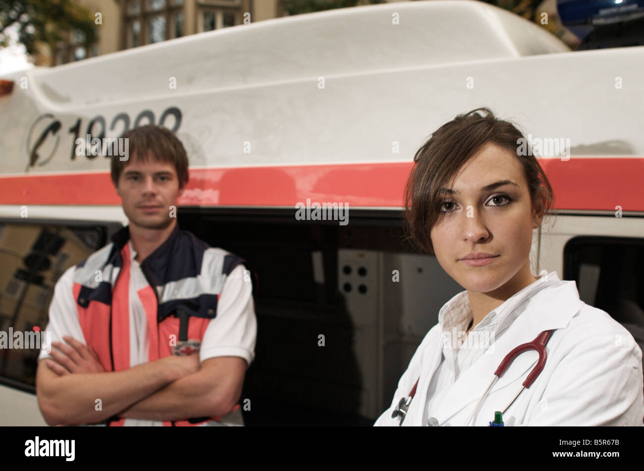 Young doctor and paramedic standing by an ambulance Stock Photo - Alamy